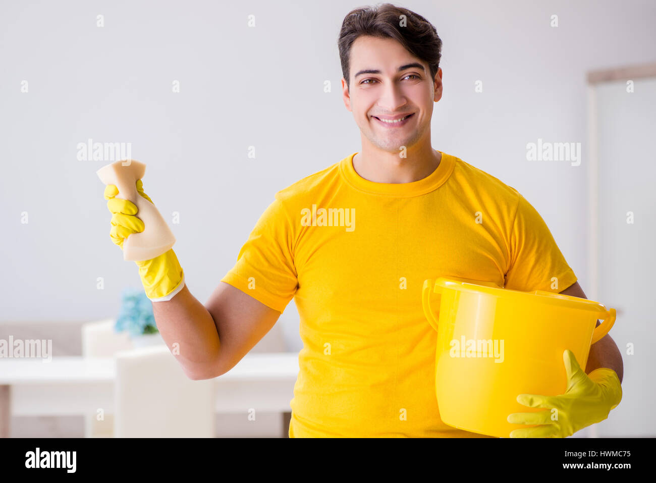 Man cleaning the house helping his wife Stock Photo - Alamy