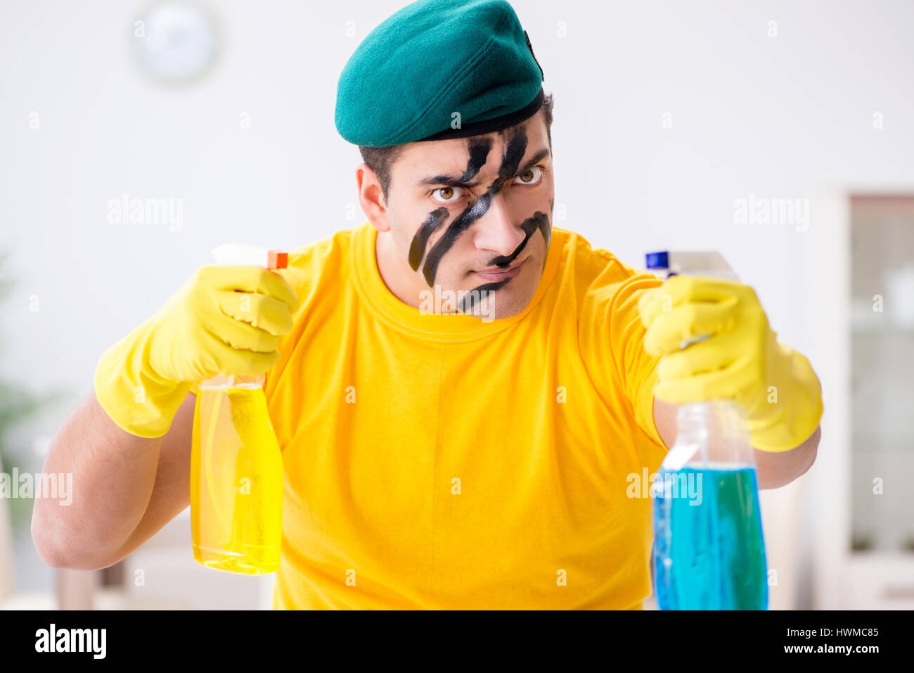 Man in military style cleaning the house Stock Photo - Alamy
