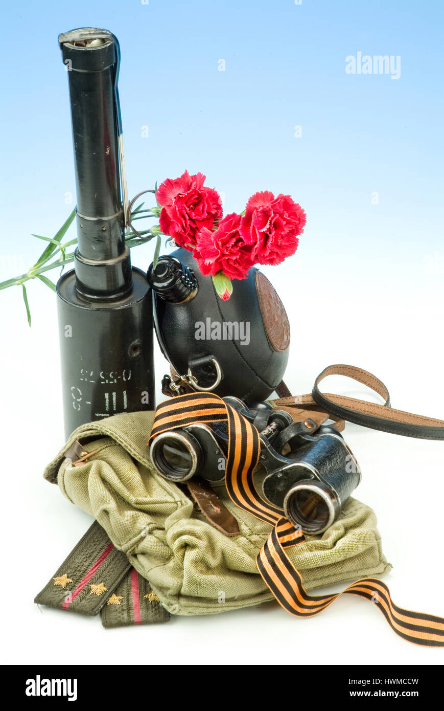Flowers and army equipment on a studio background Stock Photo - Alamy