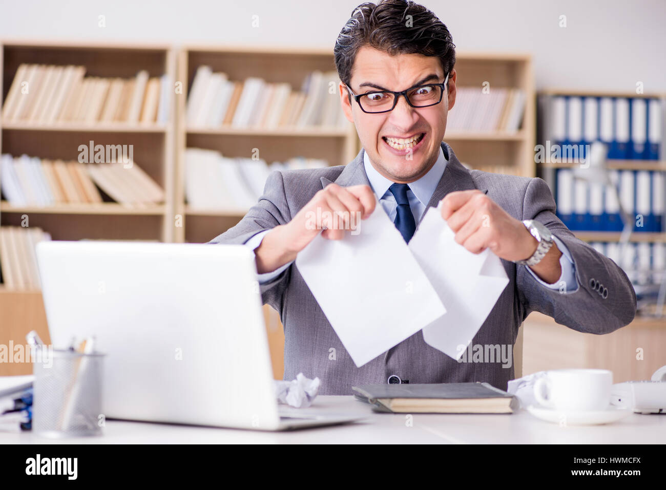 Angry businessman with too much work in office Stock Photo - Alamy