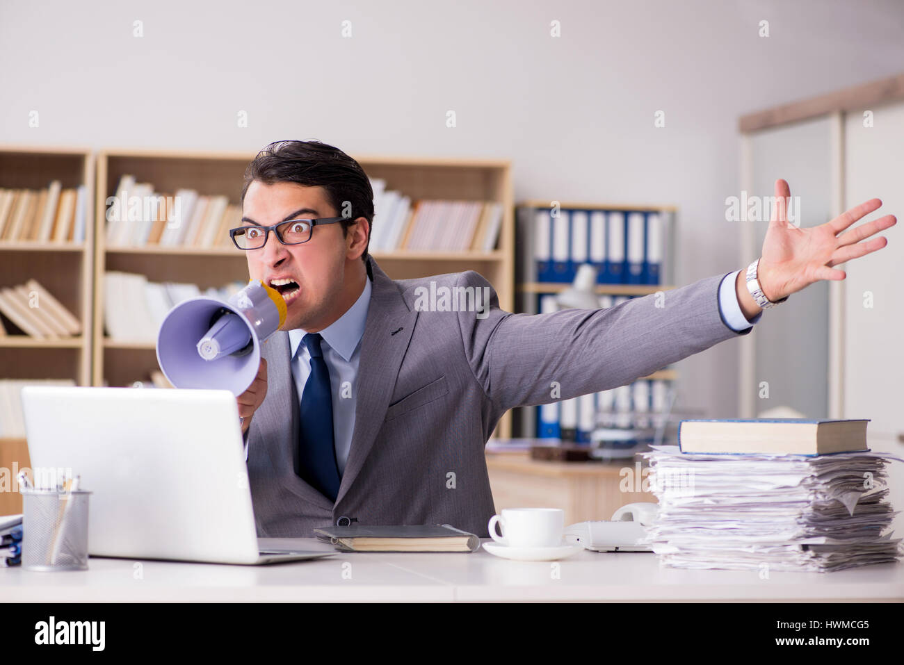 Angry businessman working in the office Stock Photo - Alamy