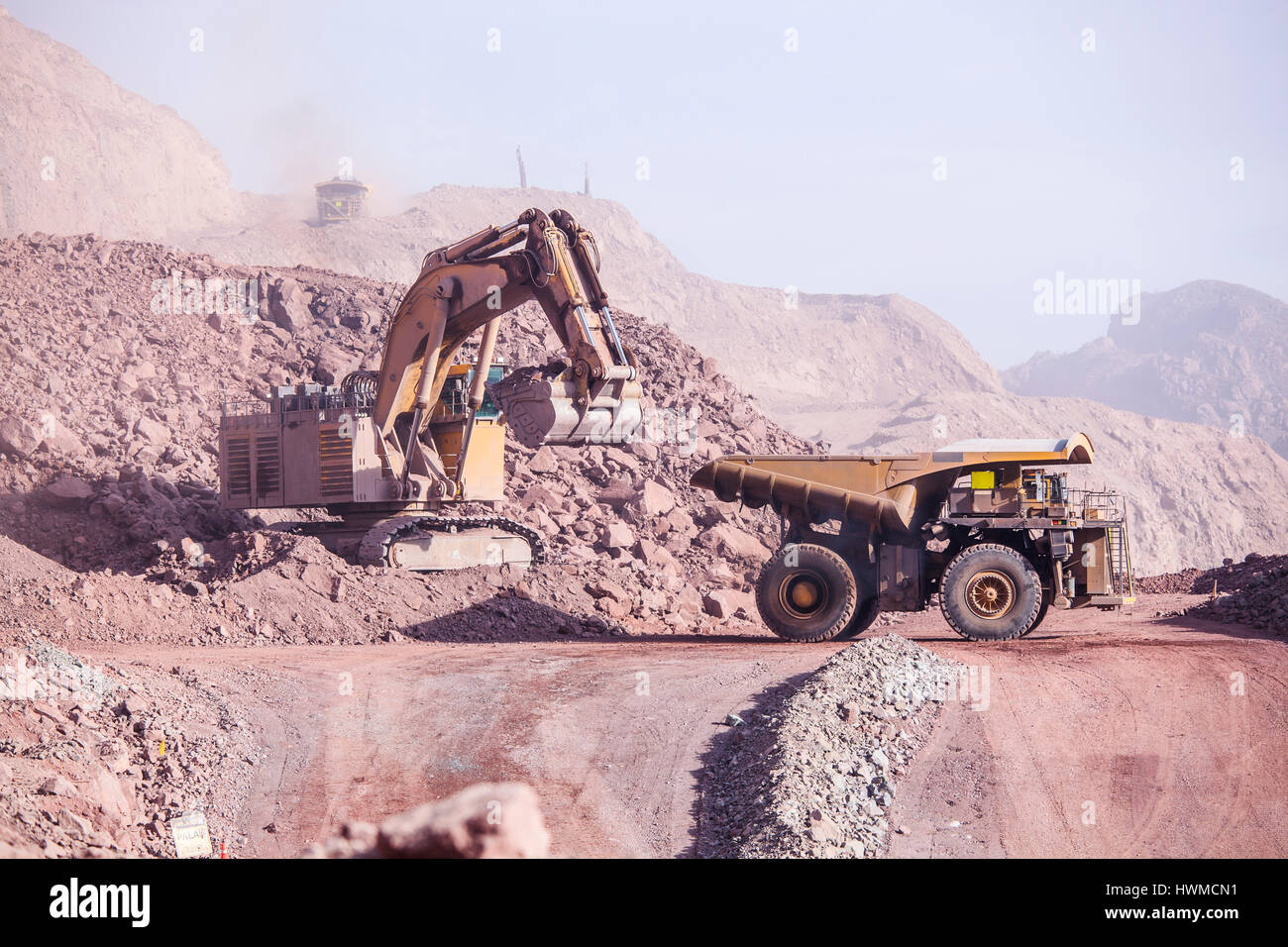 Loading of copper ore on very big dump-body truck Stock Photo - Alamy