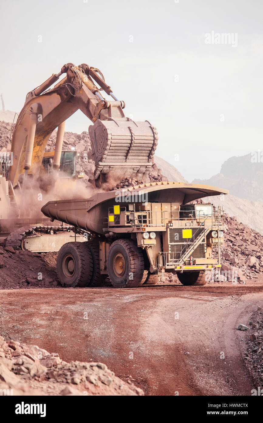 Loading of copper ore on very big dump-body truck Stock Photo - Alamy