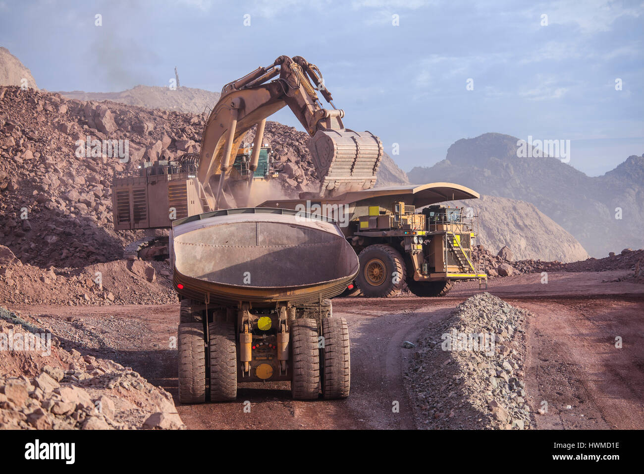 Loading of copper ore on very big dump-body truck Stock Photo - Alamy