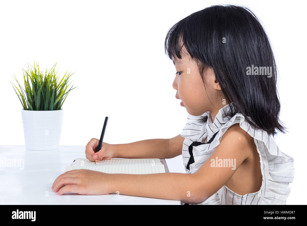 Asian Chinese little office lady writing book on the desk in isolated ...