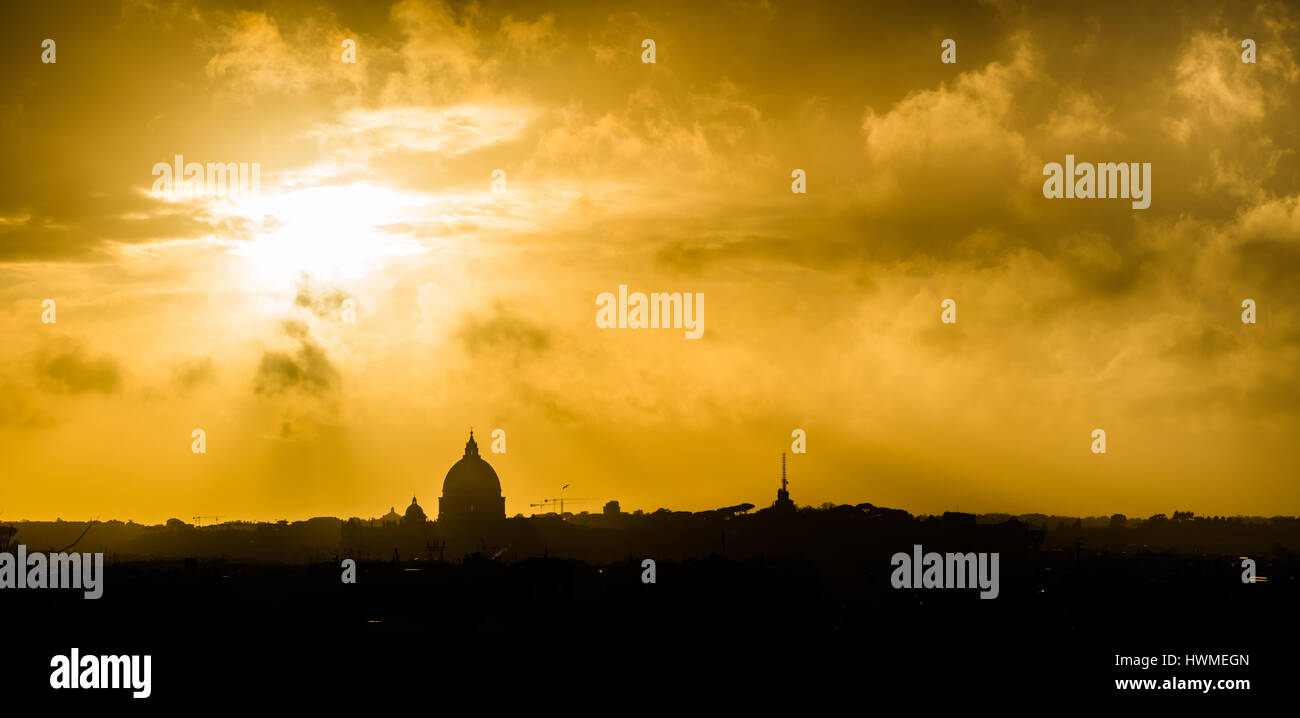 Golden sunset with clouds over the city of Rome, Italy. The silhouette ...