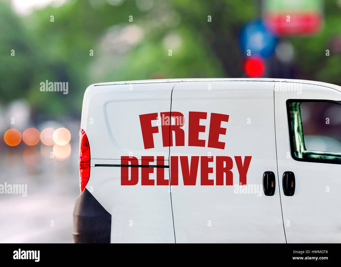 Free delivery, van on city street Stock Photo - Alamy