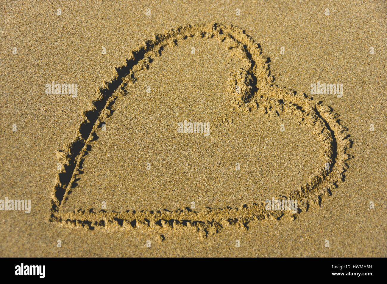 Lovely heart in sand at the beach Stock Photo - Alamy