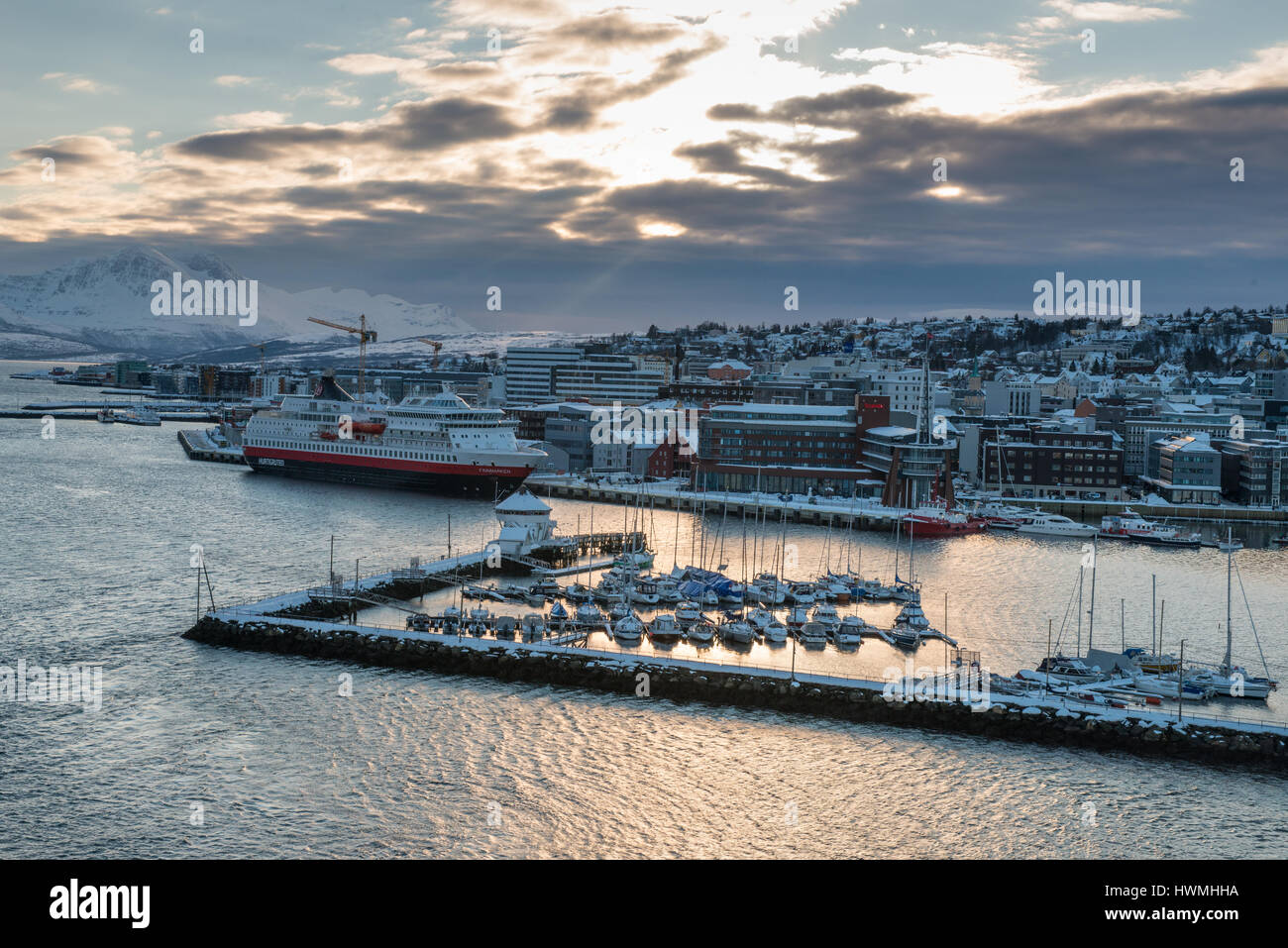 The harbour of Tromso and the view of Hurtigruten ship MS Finnmarken at ...