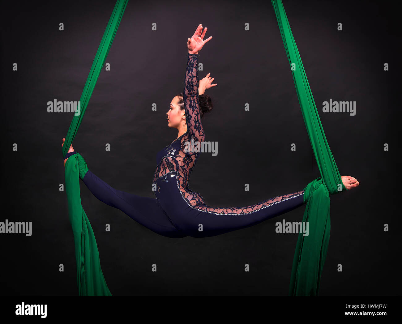 woman's aerial acrobatics in the paintings - dark background. Studio ...