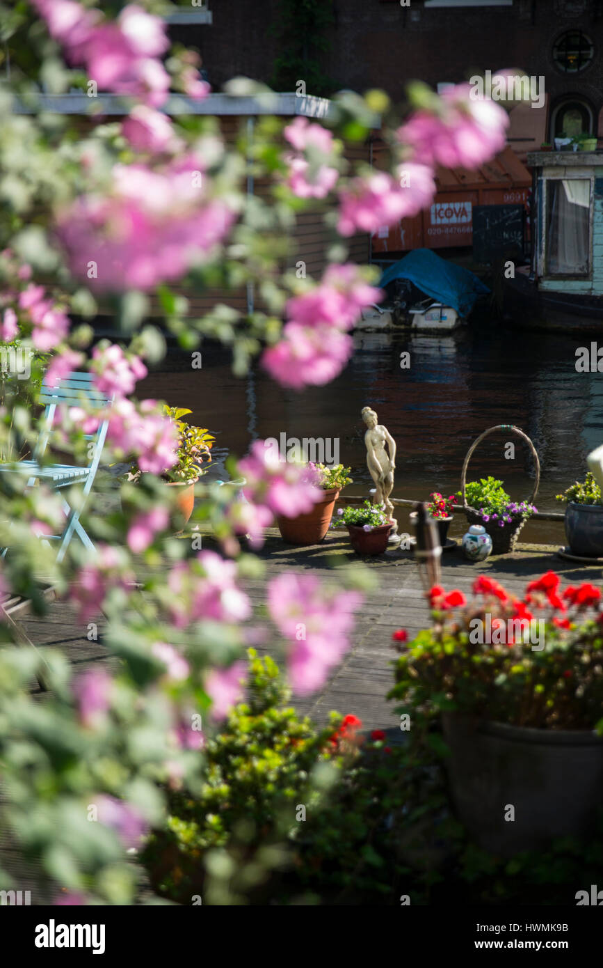 Statue in garden of canal boat, Amsterdam Stock Photo - Alamy