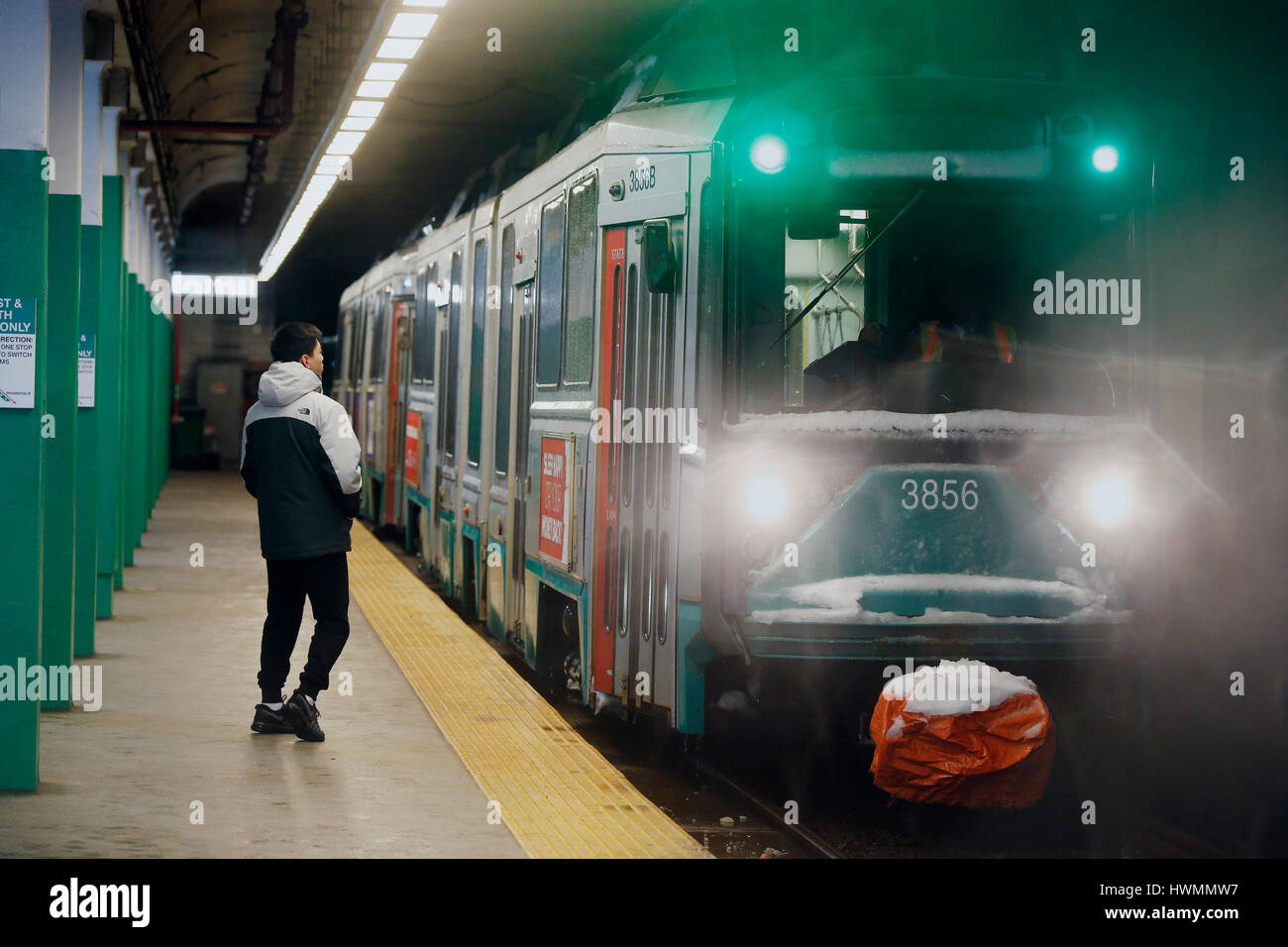 Green line public transportation trolley train pulls into the station ...