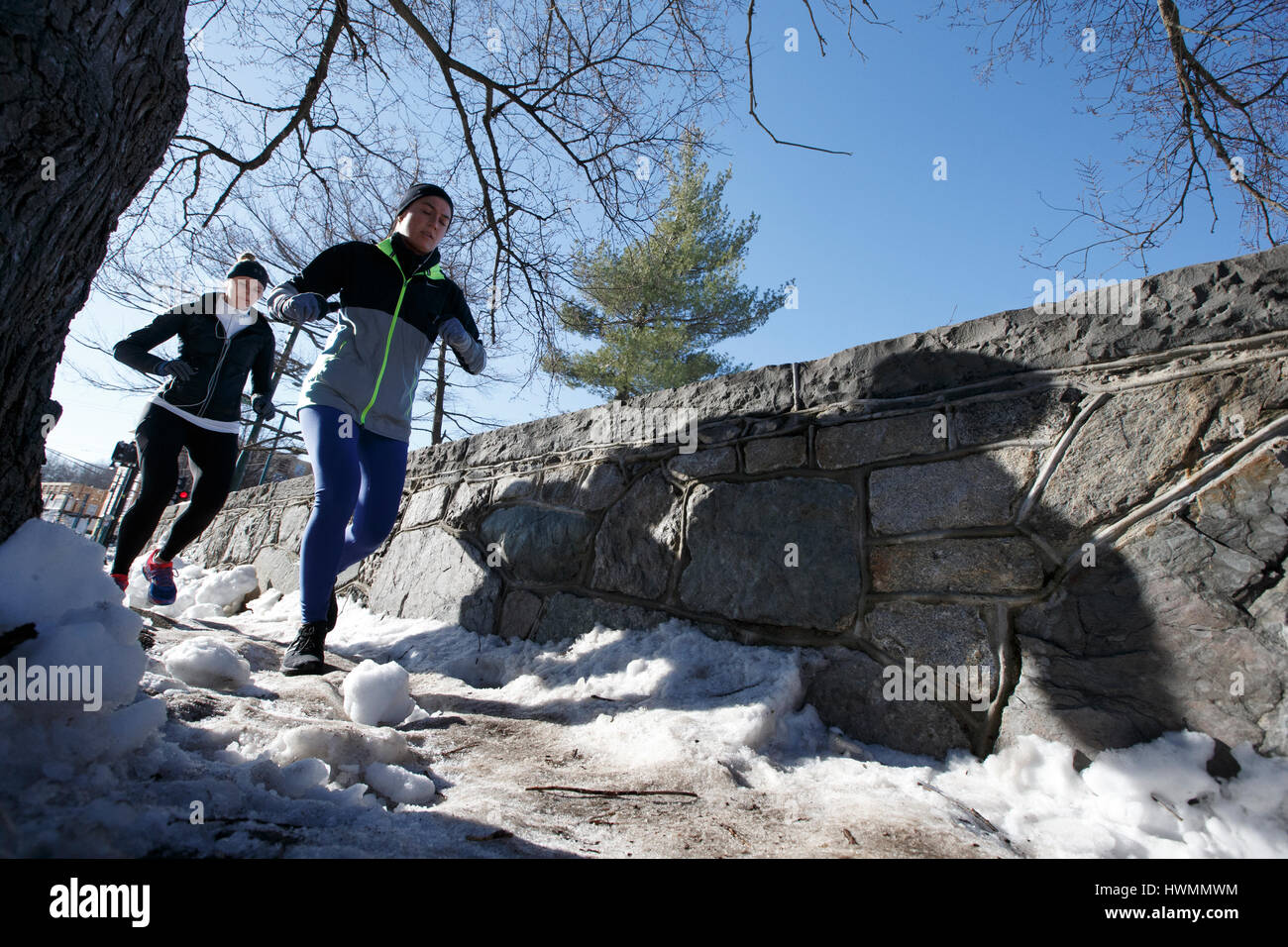 Joggers, runners on a snowy, icy city sidewalk Stock Photo - Alamy