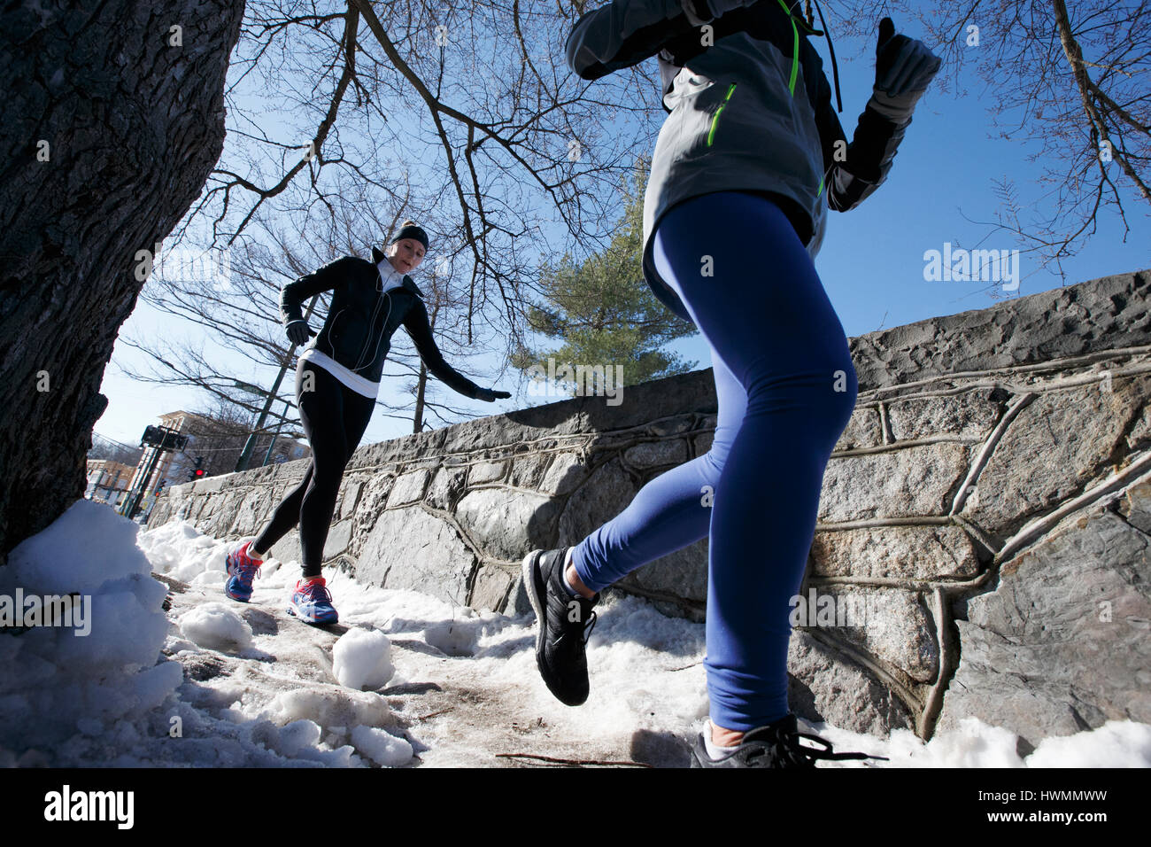 Joggers, runners on a snowy, icy city sidewalk Stock Photo - Alamy