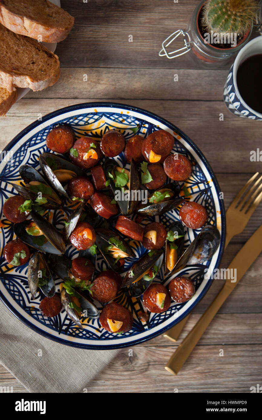 Surf and turf: A homemade bowl of mussels and chorizo on a table ...