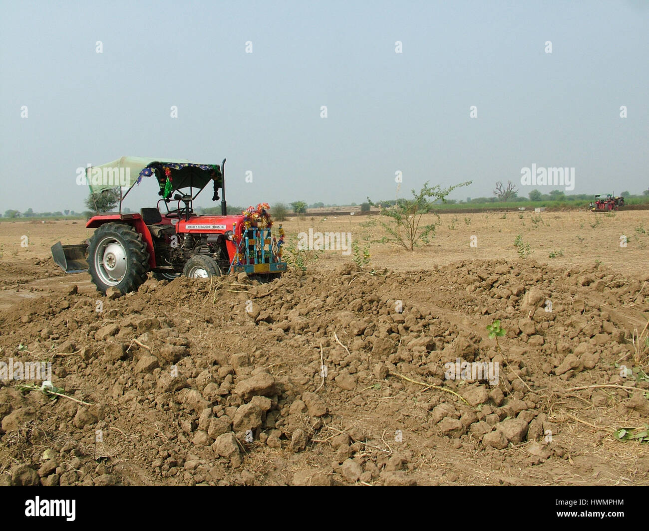 Tractor at Paddy land, developing, agricultural land (Copyright © Saji ...