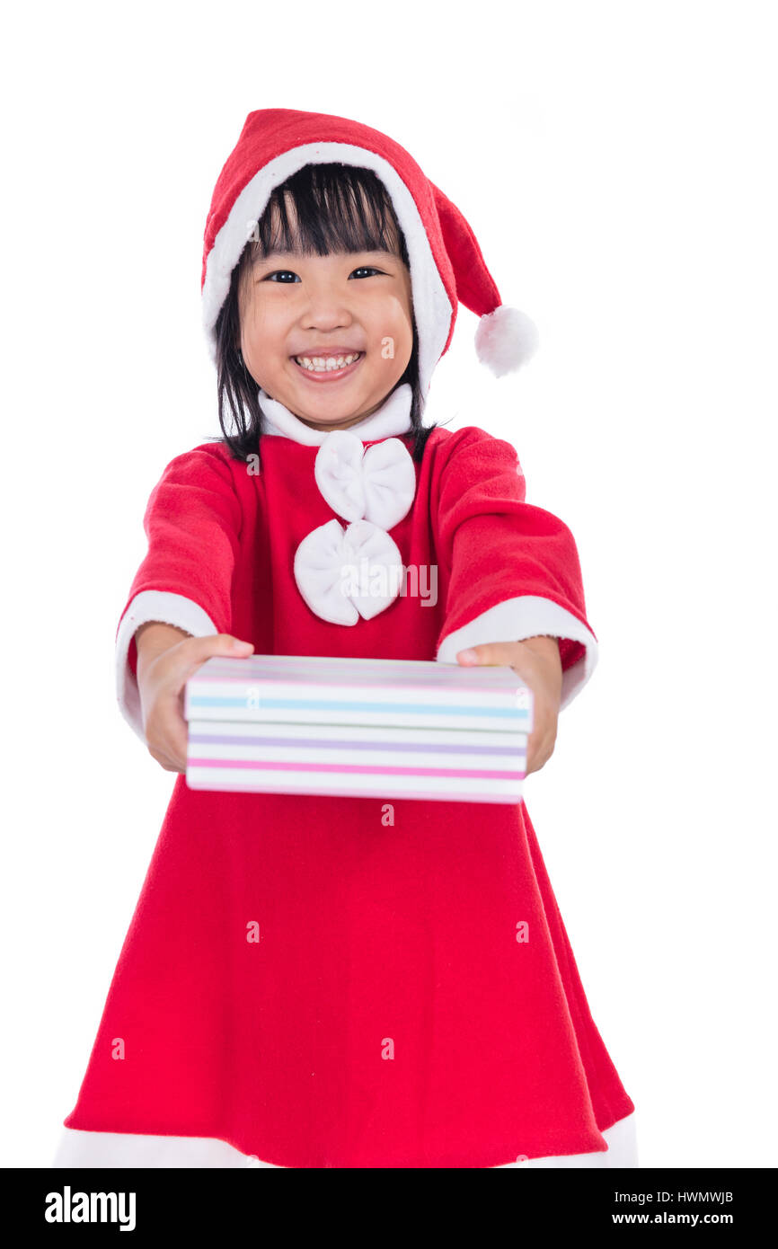 Asian Chinese little girl in santa costume holding gift box in isolated ...