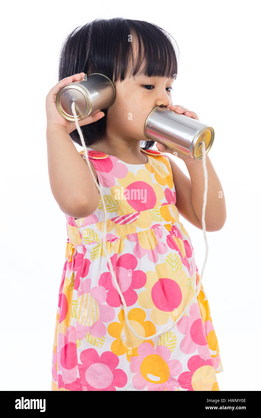 Asian Chinese little girl playing tin can phone in isolated white ...