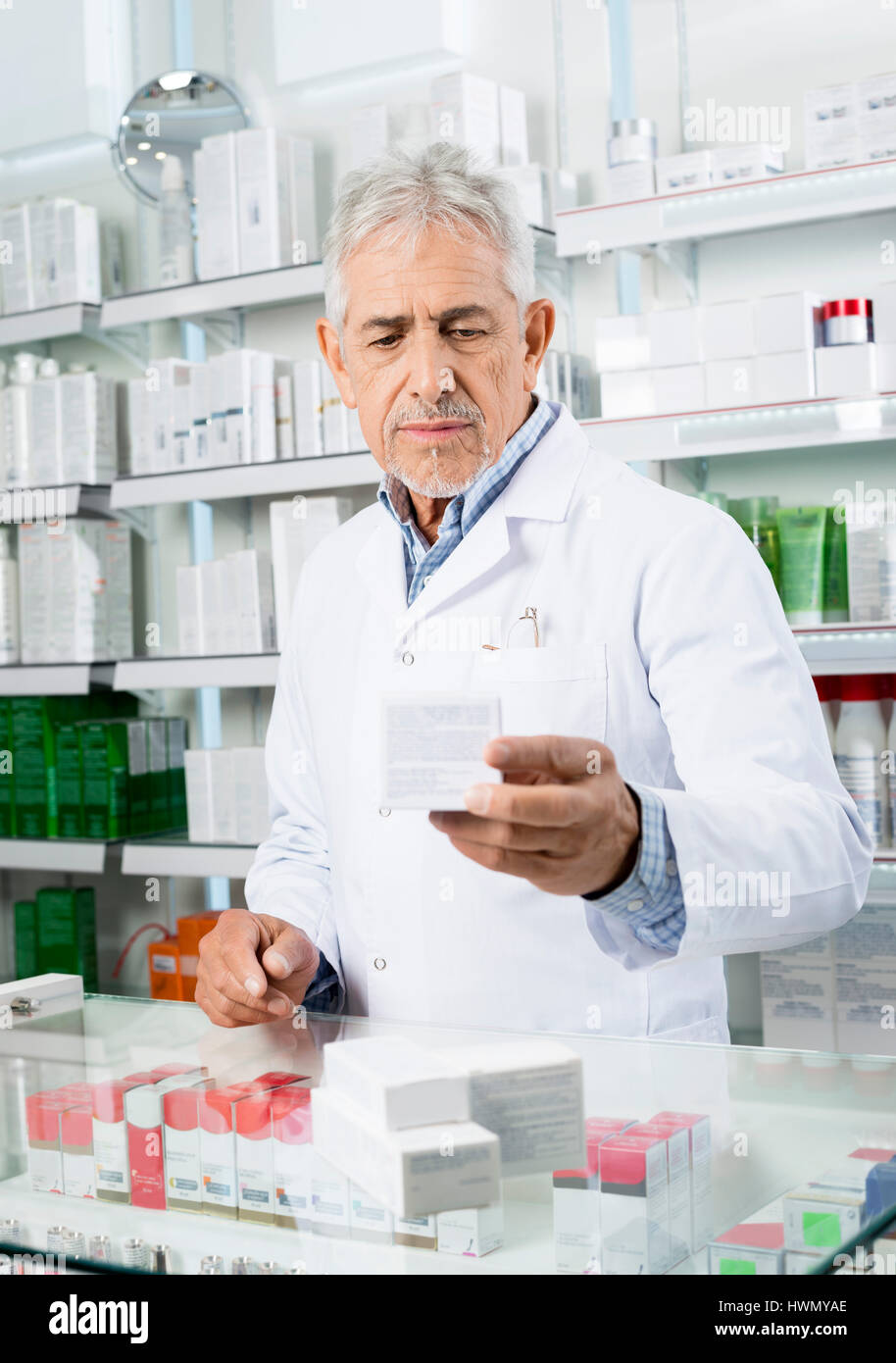 Chemist Holding Medicine At Counter In Pharmacy Stock Photo - Alamy