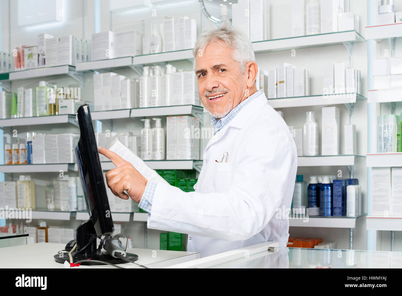 Smiling Pharmacist Touching Monitor Screen In Pharmacy Stock Photo - Alamy