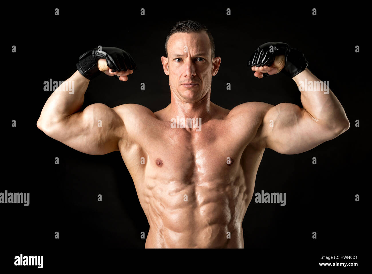 Strong Mixed Martial Arts fighter isolated in black Stock Photo - Alamy