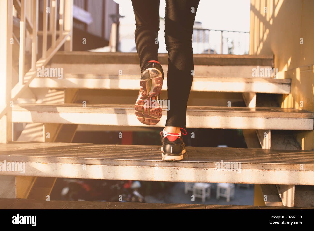 Close up of feet with sneakers climbing up the stairs Stock Photo - Alamy
