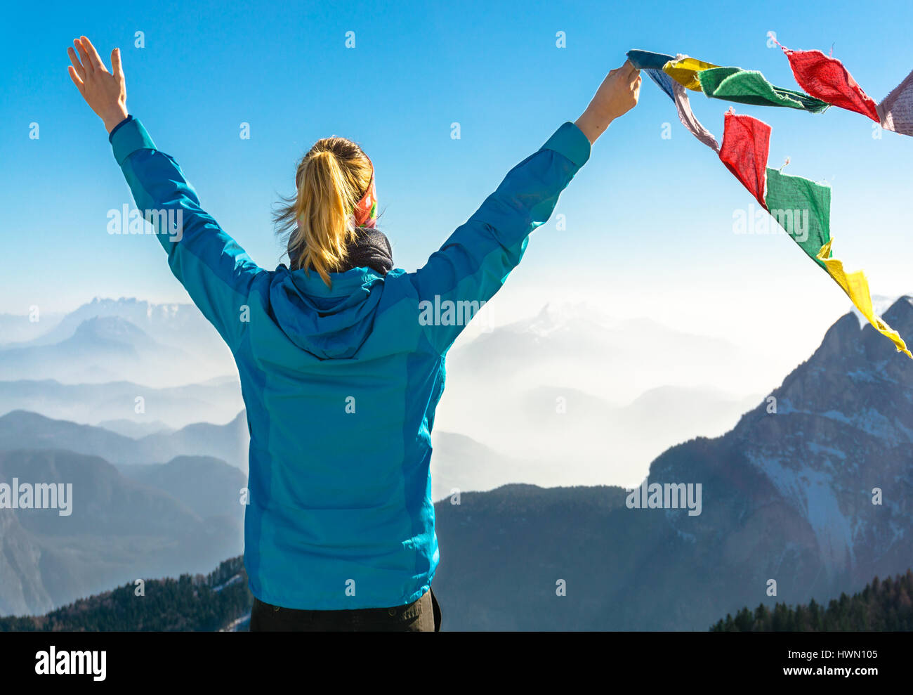 Happy success winning woman on summit arms up holding flag Stock Photo ...