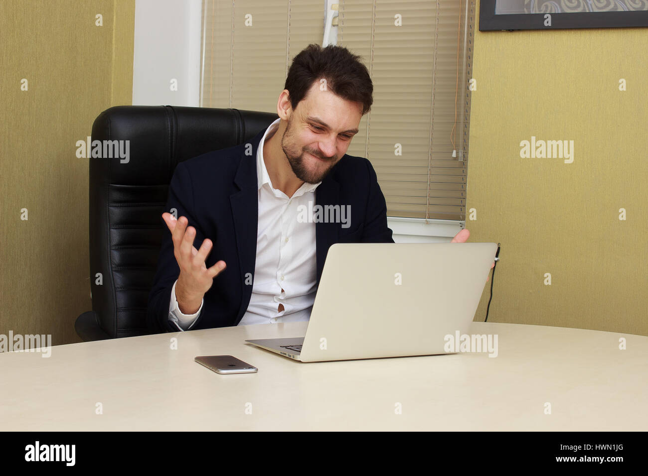 Prayer at work. businessman sitting at desk on a laptop while a ...