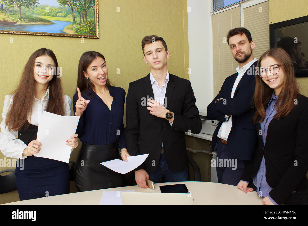 Group portrait of professional business team looking confidently at ...