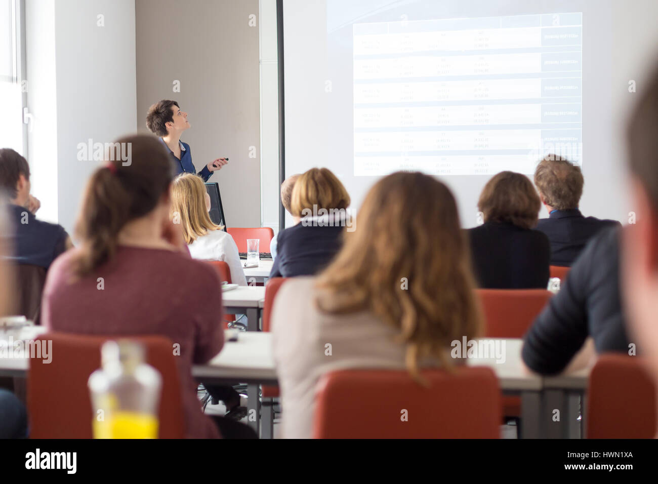 Woman giving presentation in lecture hall at university Stock Photo - Alamy