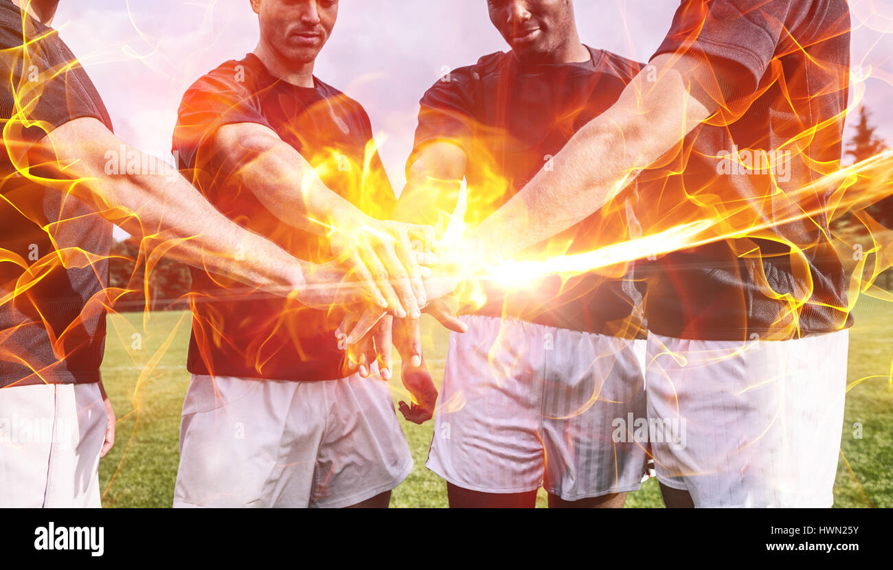 Ball of fire against rugby players standing together before match 3d ...