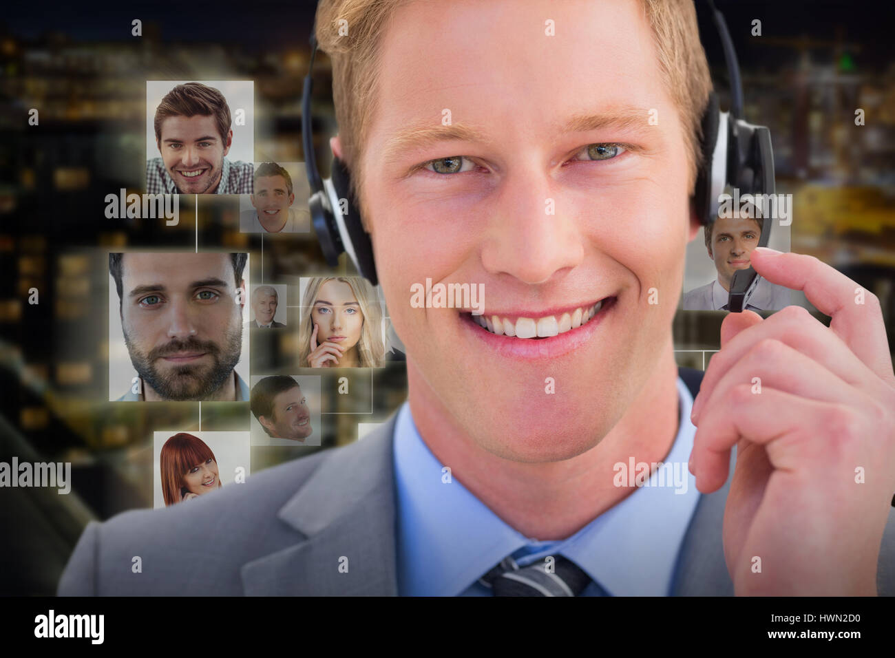 Handsome agent wearing headset against illuminated beautiful buildings ...