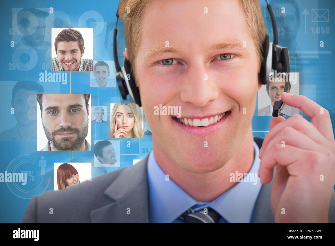 Handsome agent wearing headset against blue background Stock Photo - Alamy