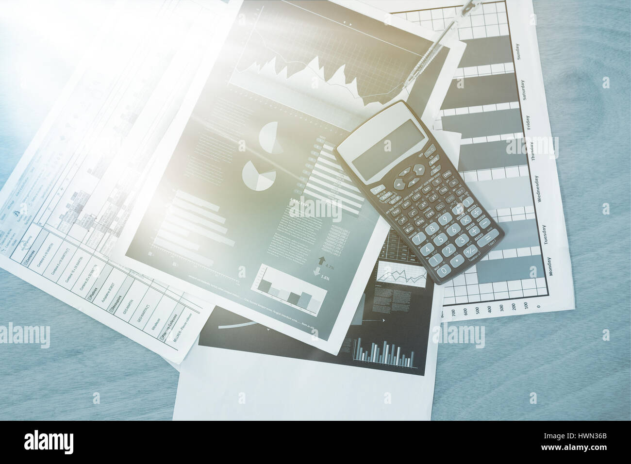 Sheets of graph with calculator on wooden table Stock Photo - Alamy