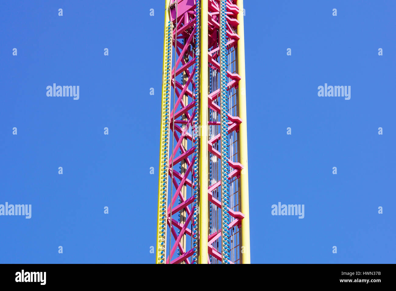 large flying carousel ride machine turning against the blue sky in a ...