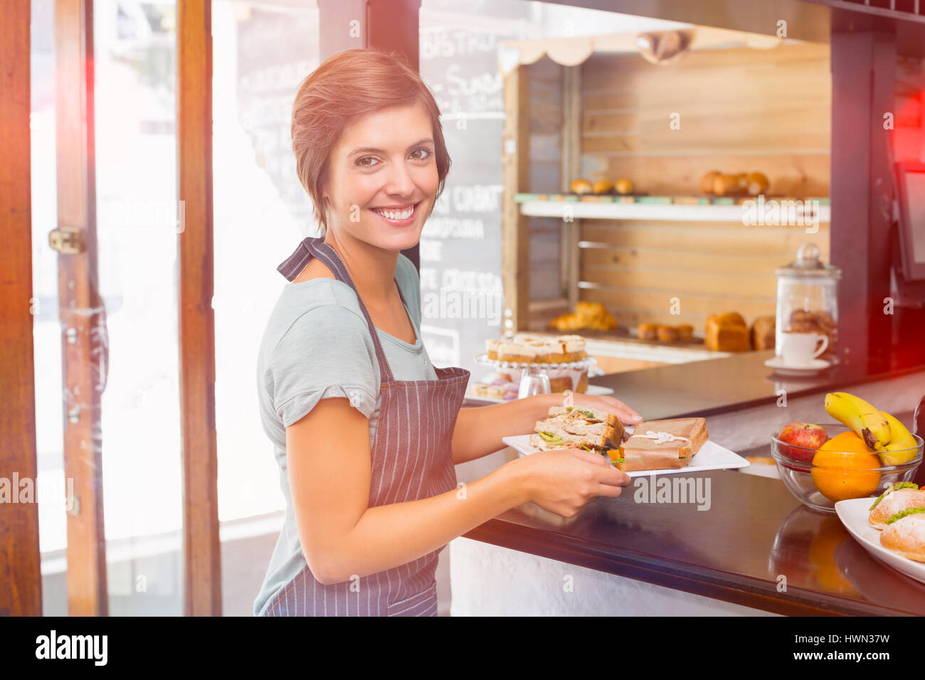 Graphic image of flare against pretty waitress holding plate of food ...