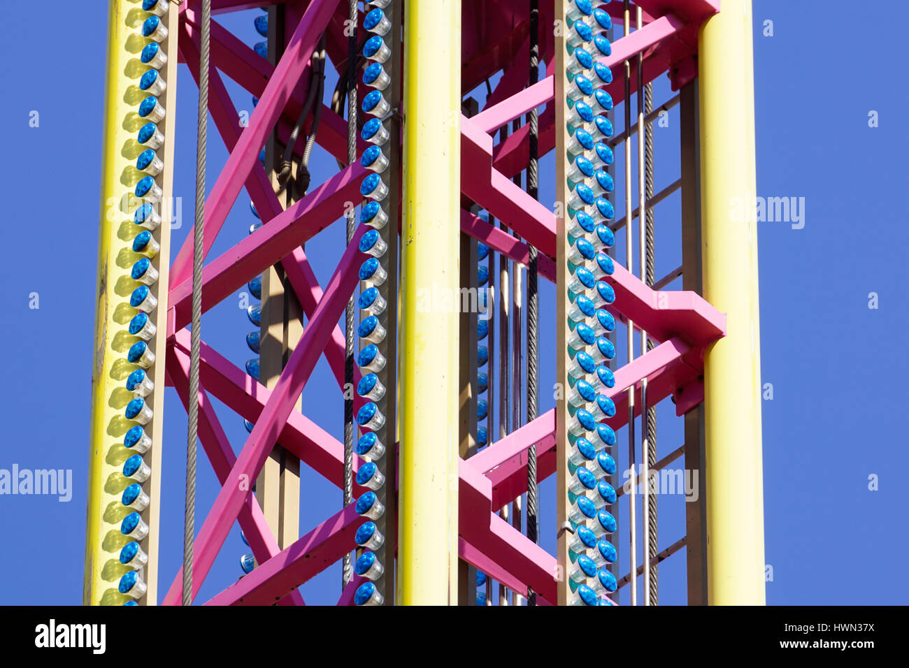 large flying carousel ride machine turning against the blue sky in a ...