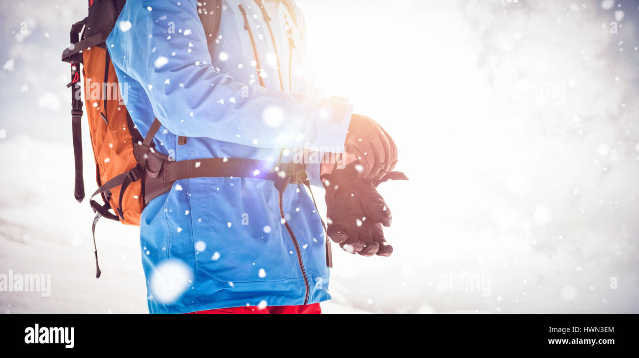 Skier wearing hand gloves while getting ready for skiing Stock Photo ...