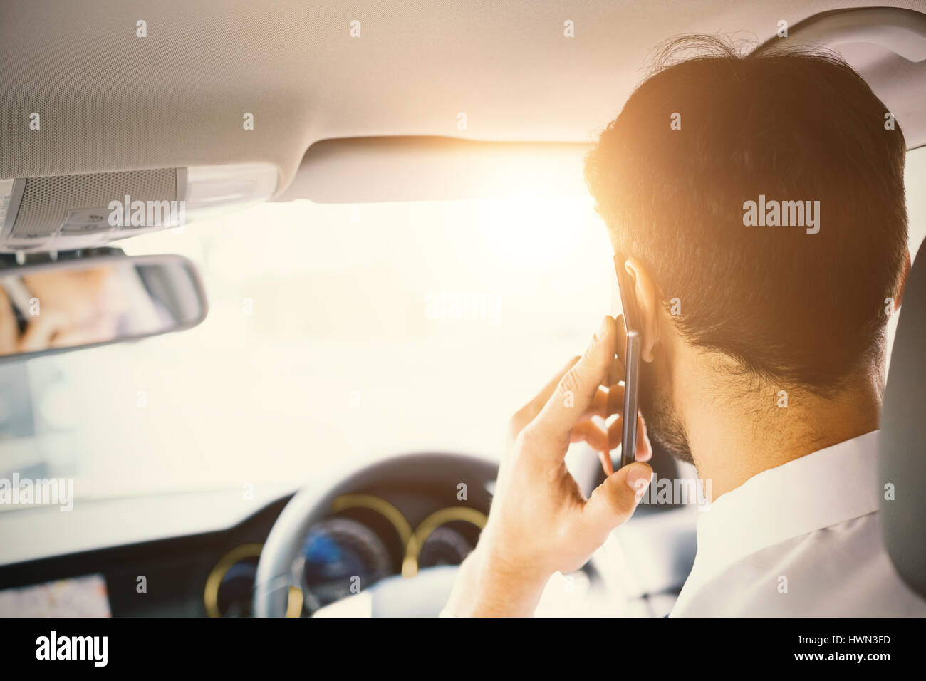 Men driving a car with his phone Stock Photo - Alamy