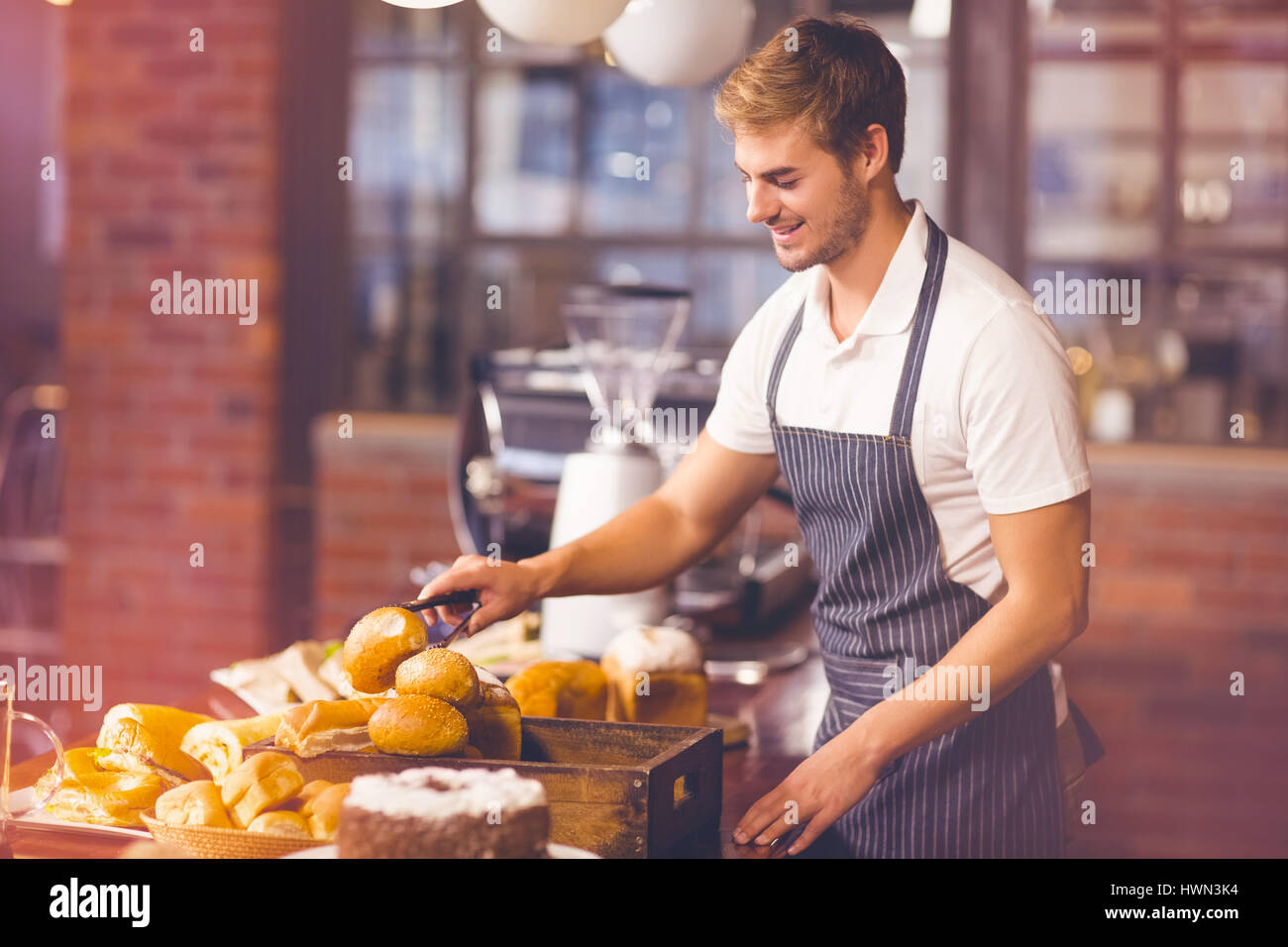 Graphic image of flare against handsome waiter picking up bun Stock ...