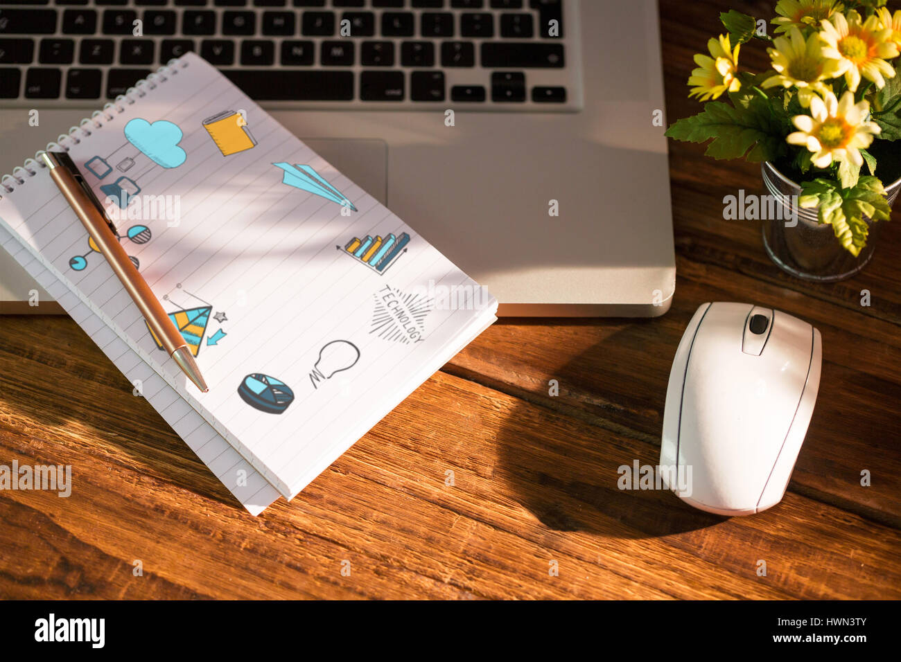 Composite image of computer icons against overhead view of an desk ...