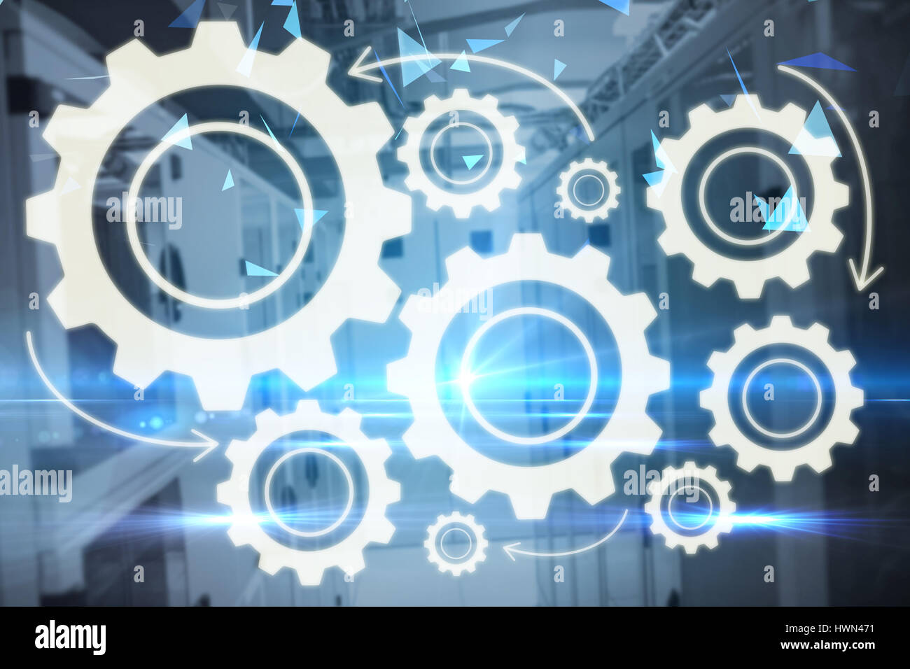 Composite image of gears on white background against small pyramids on ...