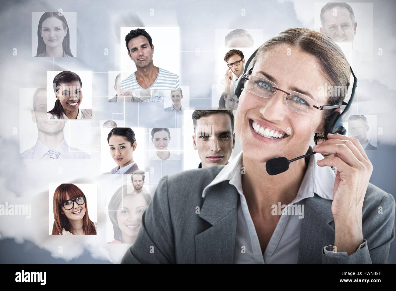 Portrait of a call center executive wearing headset against grey ...
