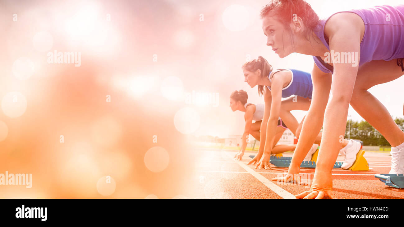 Side view of women on starting line of track field Stock Photo - Alamy