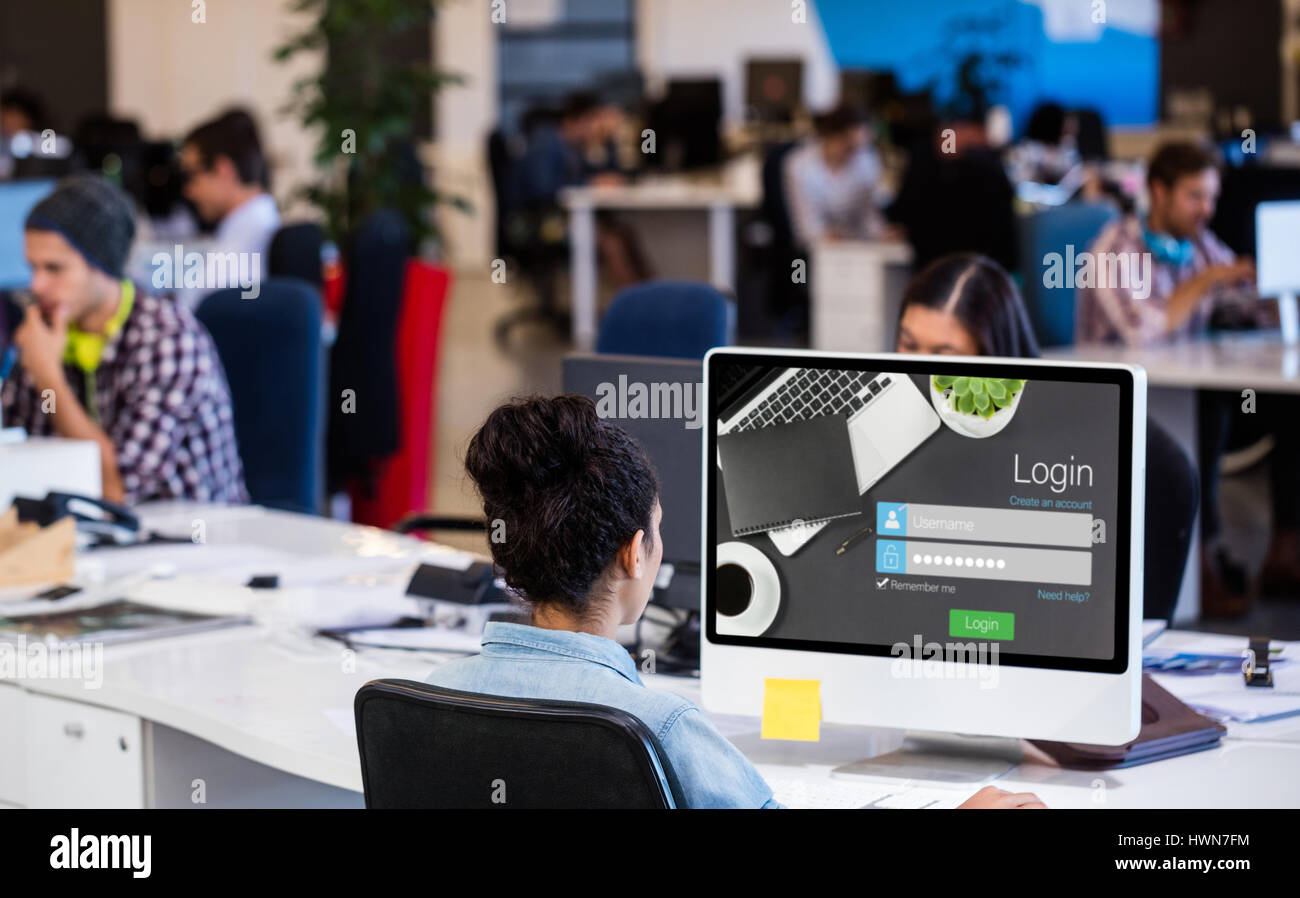 Close-up of login page against people working on computer Stock Photo ...