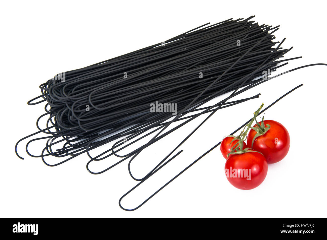 Black spaghetti on white background Stock Photo - Alamy