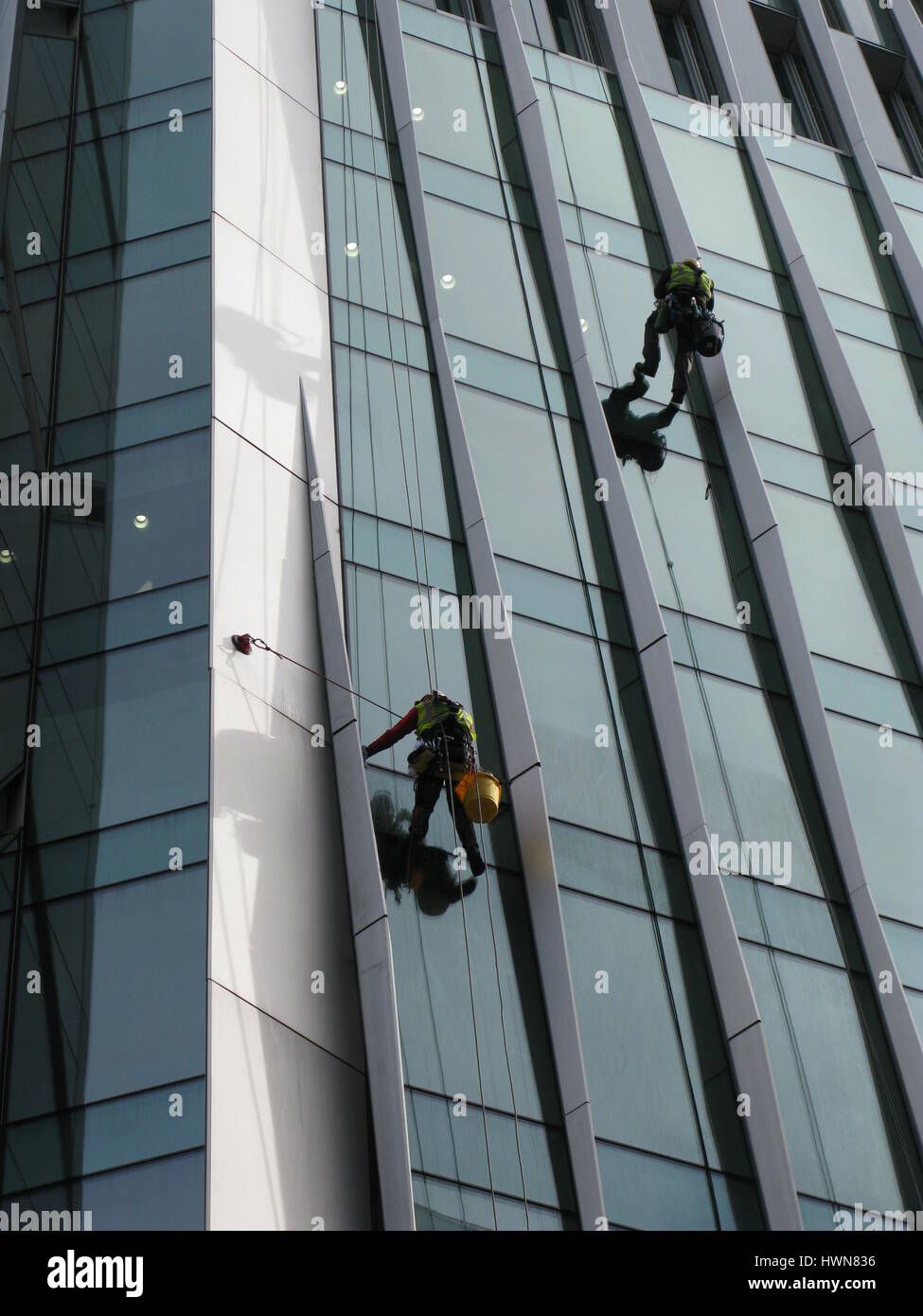 London, United Kingdom - March 14, 2016: Construction abseilers fix ...