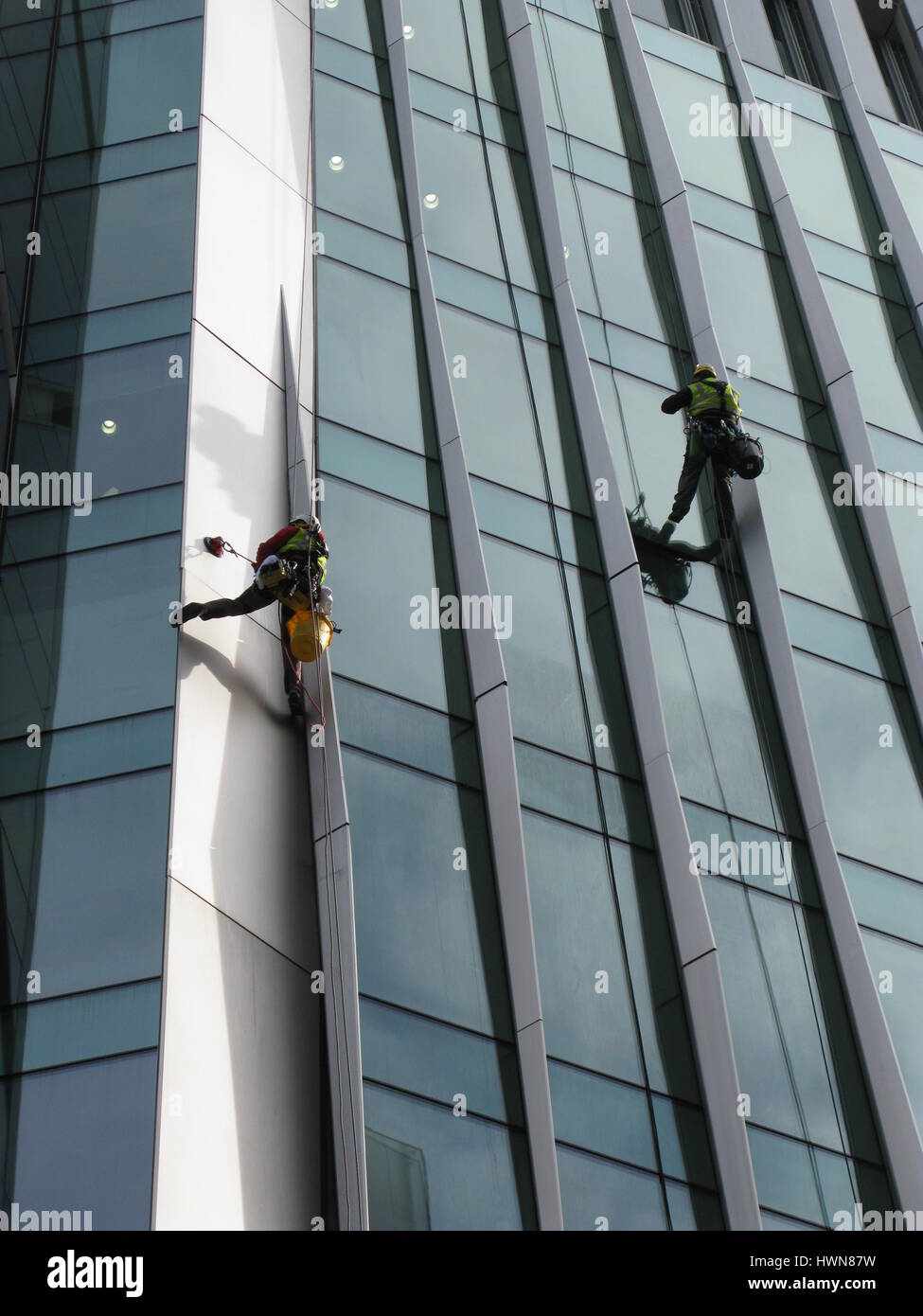 London, United Kingdom - March 14, 2016: Construction abseilers fix ...