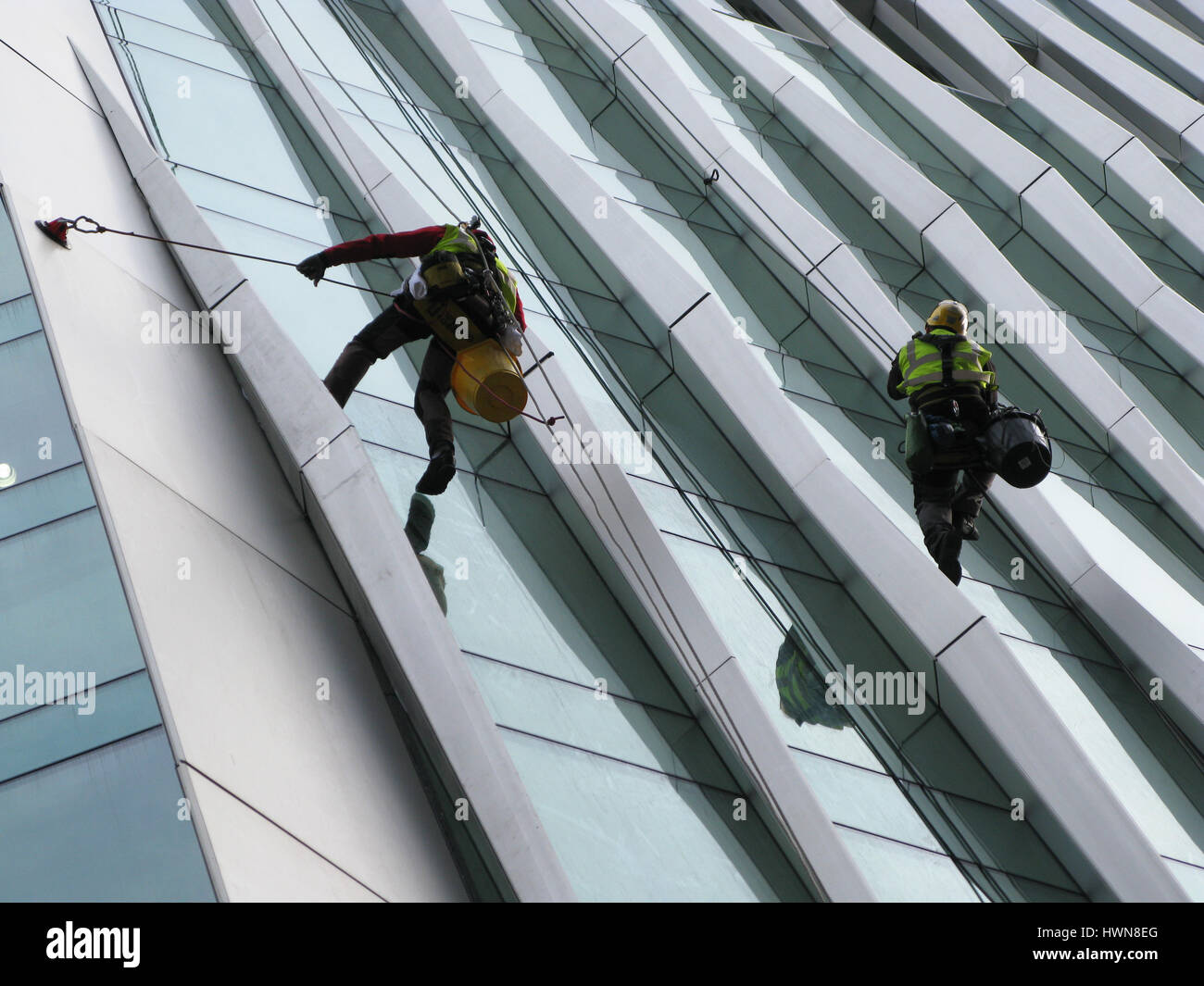London, United Kingdom - March 14, 2016: Construction abseilers fix ...