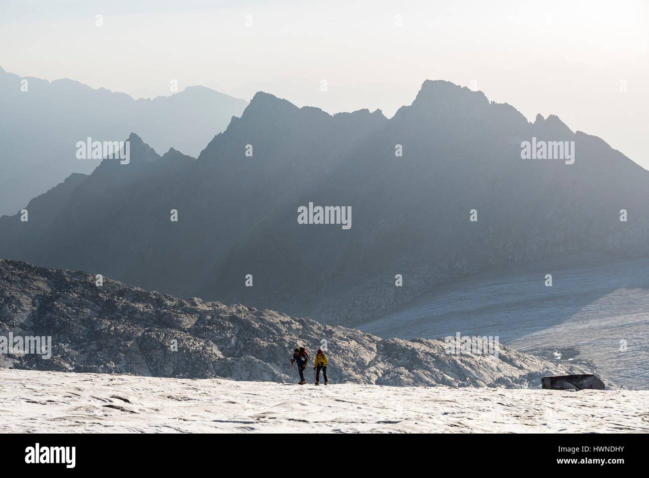 Italy, Lombardy, Temu, hikers walking along the glacial Lobbia towards ...